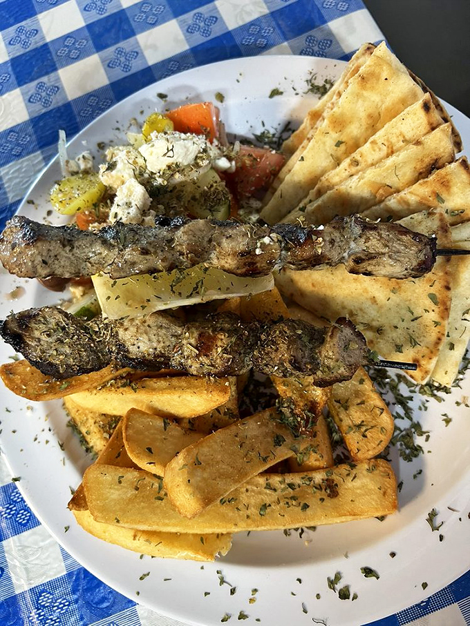 Two plates that tell the story of Greece better than any history book. The feta-topped salad is practically wearing a tiny toga.