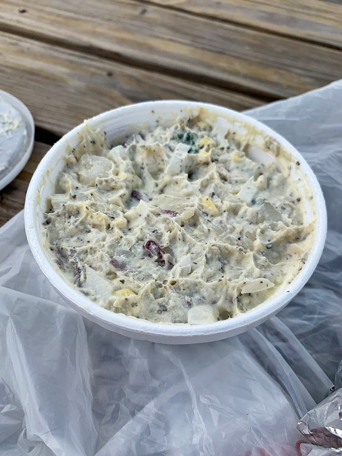 Potato salad that actually looks homemade, not scooped from an industrial tub. Those red specks aren't just color—they're flavor ambassadors in a creamy potato kingdom.
