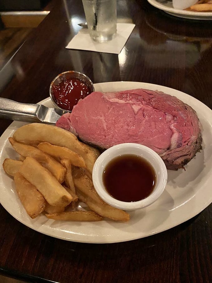 When prime rib and golden fries share a plate, it's like comfort food royalty holding court. That au jus cup is basically liquid treasure.