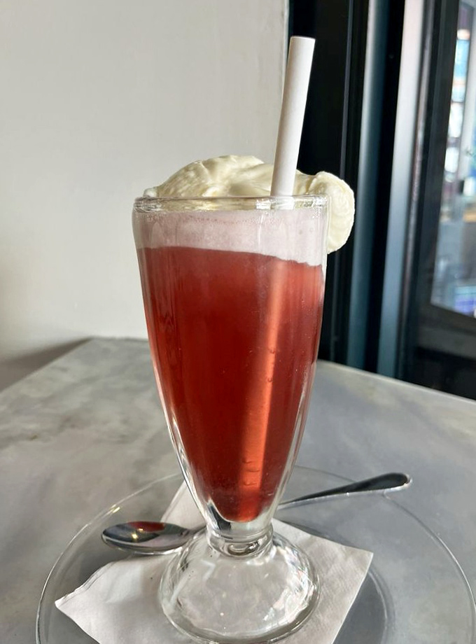 Ruby-red soda topped with a cloud of vanilla. This float isn't just a drink—it's what childhood memories would look like if they took liquid form.