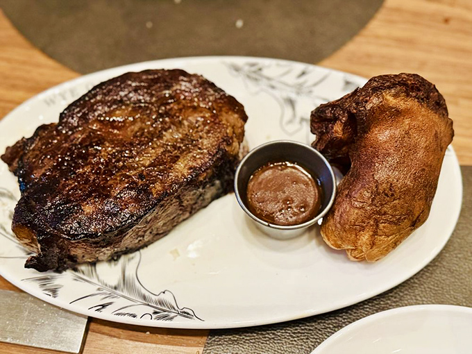 The steak arrives with a sear that would make Maillard himself weep with joy. That crust deserves its own fan club.