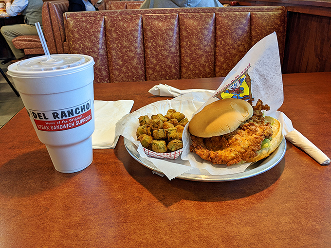 A meal that speaks fluent Oklahoman: crispy steak sandwich, golden fried okra, and a cup proclaiming its allegiance. No translator needed.