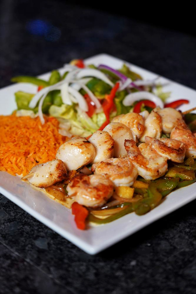 Shrimp that look like they've been kissed by fire, nestled against vegetables that haven't forgotten their natural crunch. This is how seafood should dress for dinner.