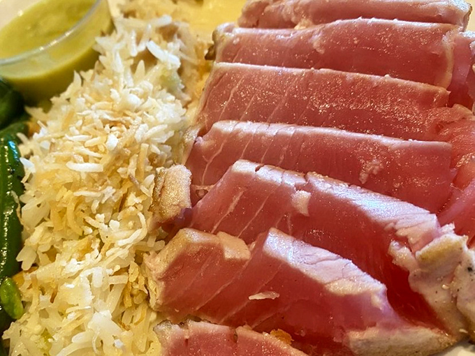 Perfectly seared ahi tuna meets coconut rice in a culinary handshake that proves Angela's Kitchen isn't just about European classics&mdash;they've got range.