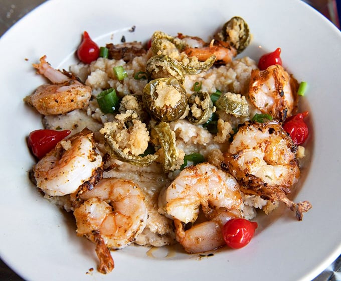 Shrimp and grits elevated to an art form. Those plump shrimp lounging on creamy grits with crispy jalape&ntilde;os are having a party you want to join.