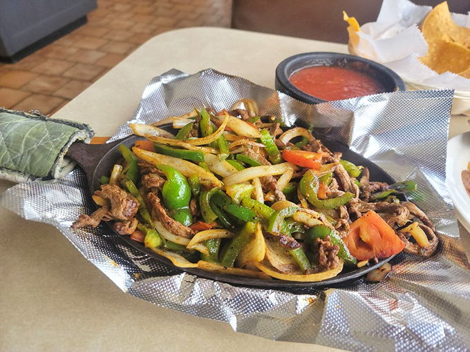 Sizzling fajitas that announce their arrival before you see them. The steam rising off this skillet carries aromas that should be bottled and sold as perfume.
