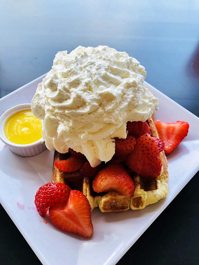 A mountain of whipped cream crowns fresh strawberries and golden waffle&mdash;dessert masquerading as breakfast and fooling absolutely no one.