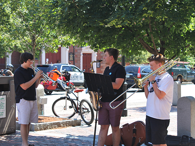 Impromptu brass performances fill Market Square with melody. These sidewalk serenades represent the kind of authentic entertainment that streaming services can't replicate.