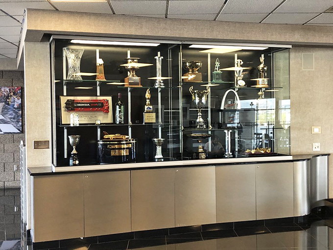 Trophy heaven! Each gleaming cup and plate represents a champagne-soaked moment of triumph, decades of victory captured behind glass.