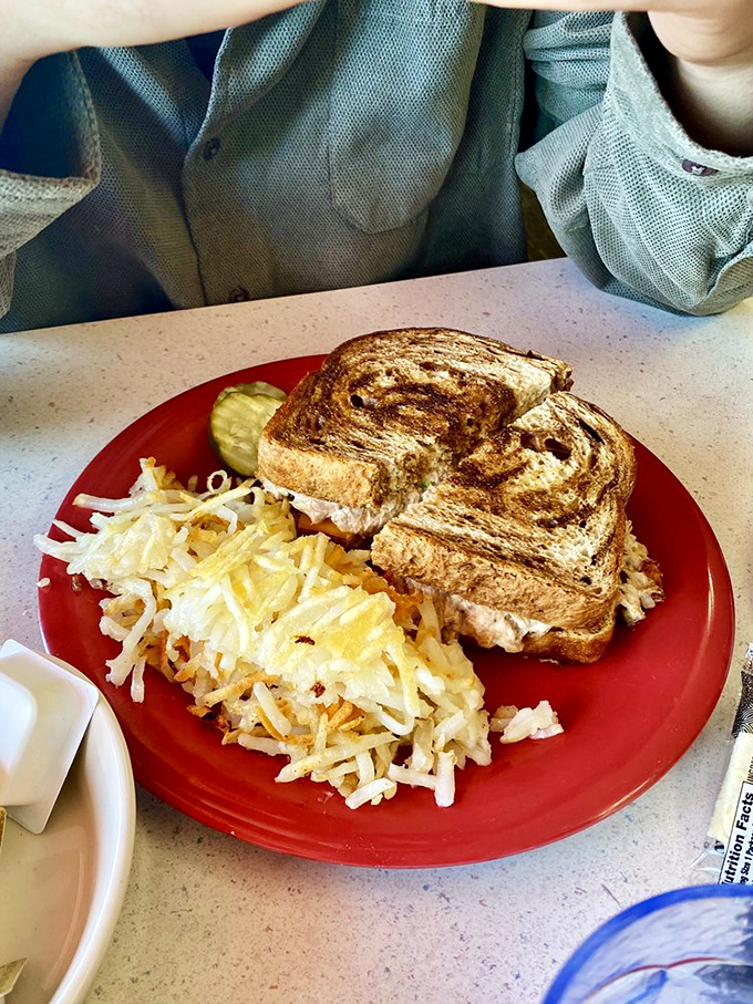A sandwich so perfectly grilled it belongs in the Comfort Food Hall of Fame, with hash browns that crunch loud enough to wake the neighbors.