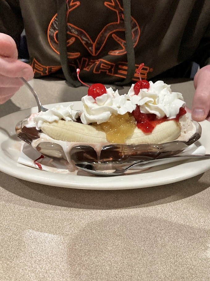 The banana split arrives like a dessert parade&mdash;whipped cream mountains, cherry flags, and banana boats sailing on rivers of sweet nostalgia.