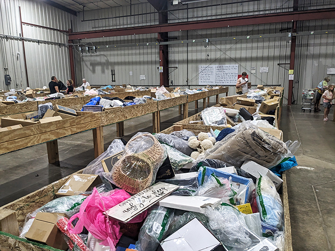 Shoppers in their natural habitat. The strategic lean-and-scan technique demonstrates years of practiced bin-diving expertise at work.
