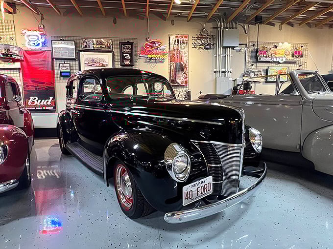 The 1940 Ford&mdash;automotive royalty in glossy black. This isn't transportation; it's time travel with whitewall tires and running boards.