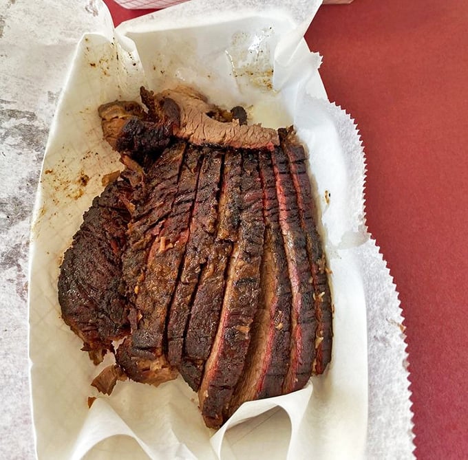 Brisket that looks like it's been kissed by smoke angels. That bark! That pink ring! That's not just meat&mdash;that's edible art.