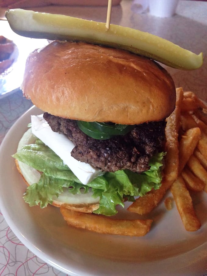 This burger isn't just served—it's presented, complete with the pickle mohawk that says "I'm not just lunch, I'm an attitude."