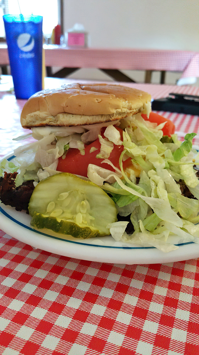 Fresh veggies piled high atop a juicy patty. This isn't just a burger—it's architecture with flavor foundations that would make Frank Lloyd Wright proud.