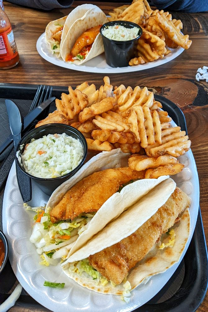 A feast fit for Neptune himself! Crispy perch tacos, waffle fries, and creamy coleslaw&mdash;the holy trinity of lakeside dining.