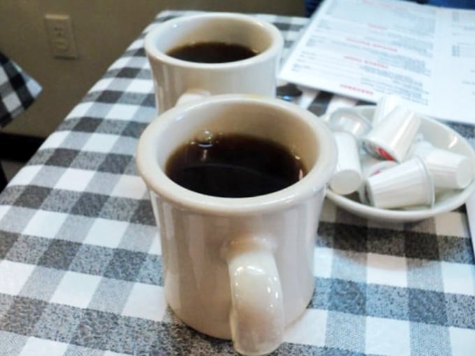 The humble white mug contains liquid ambition&mdash;diner coffee that doesn't pretend to be fancy, just reliable, like an old friend who always shows up.