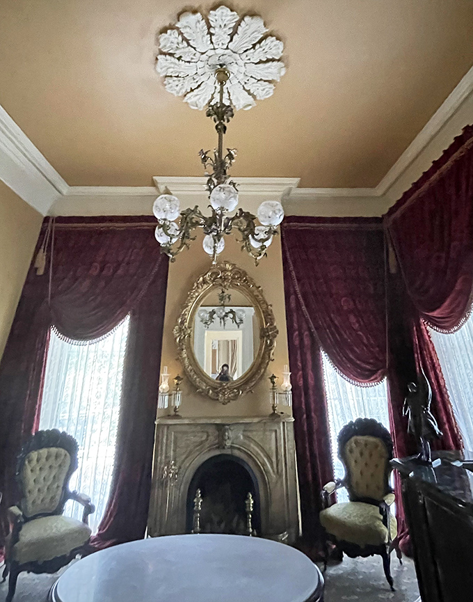 Rich burgundy drapes frame ornate fireplaces while crystal chandeliers cast a warm glow&mdash;Southern hospitality meets European grandeur.