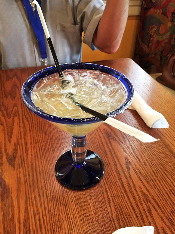A proper margarita with the telltale salt rim of authenticity. This isn't some neon-green imposter&mdash;it's the real deal that whispers, "Vacation starts now."
