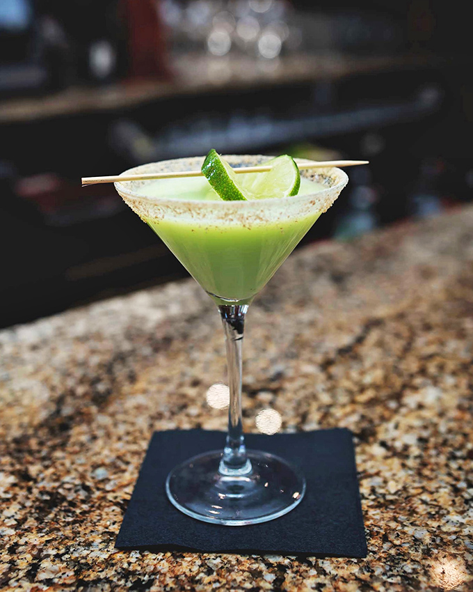 A cocktail that's dressed better than most people at formal events. This vibrant green martini proves Missouri mixology is no afterthought.