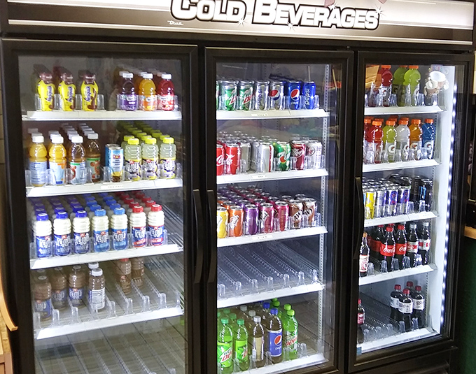 The beverage cooler stands ready for those who need something to wash down sugary perfection. Though between us, true regulars know it's all about the coffee.