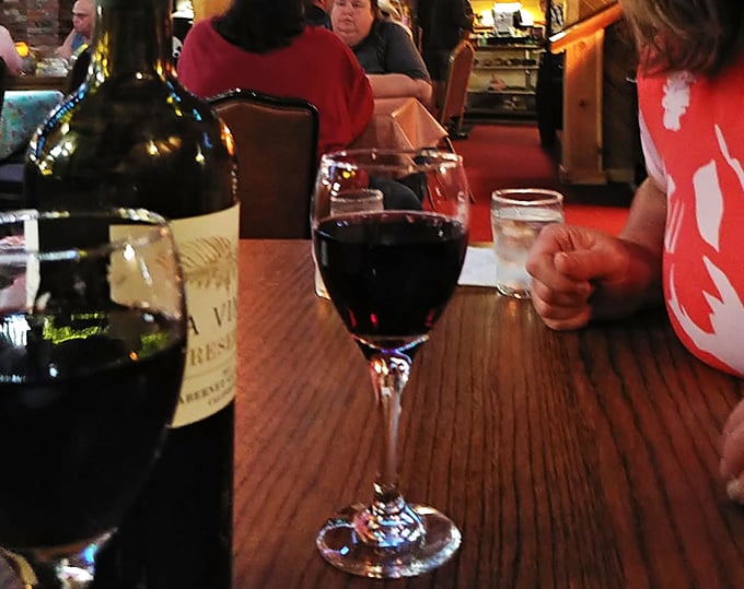 Wine glasses catching the warm light of the restaurant &ndash; a quiet moment before they become part of conversations, celebrations, and perfect meal pairings.
