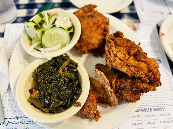 Fried chicken so perfectly golden it deserves its own Instagram filter. Those collard greens aren't just a side—they're a supporting actor worthy of an Oscar.