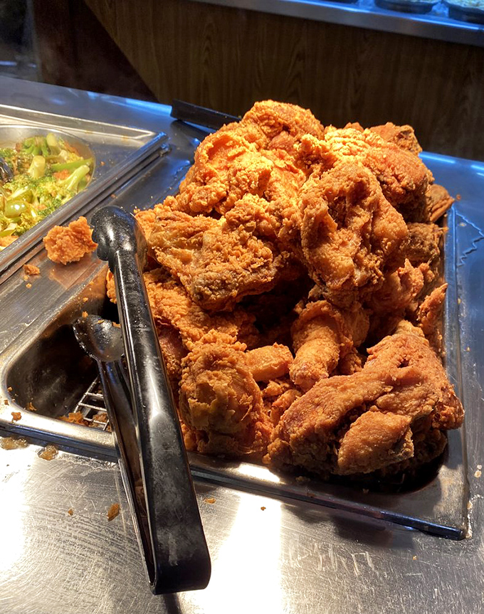 Fried chicken mountain: where crispy skin dreams come true. That golden-brown color isn't just cooking&mdash;it's an art form perfected through generations of Southern wisdom.