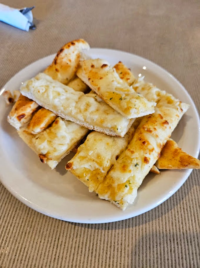 Garlic bread sticks arranged with military precision, ready to deploy directly into your mouth's flavor receptors.