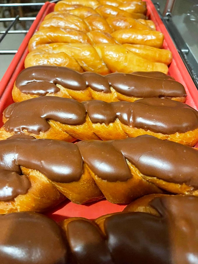 Pink and chocolate-drizzled donuts playing dress-up. They're wearing their Sunday best, but they won't last till Sunday. 