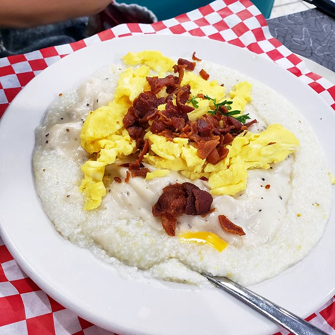Southern comfort in a bowl: creamy grits crowned with scrambled eggs and crispy bacon bits&mdash;proof that simplicity sometimes makes the most profound statements.