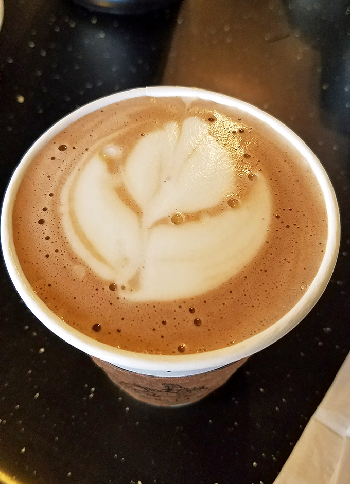 Coffee artistry that pairs perfectly with pastry indulgence. This latte's leaf design whispers, "Yes, this is technically a vegetable serving with your donut."
