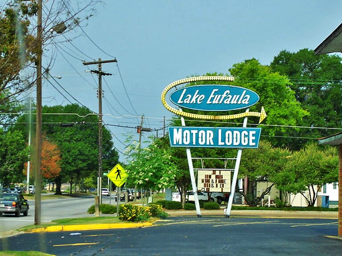 The Lake Eufaula Motor Lodge sign stands as a mid-century modern beacon, promising air conditioning and color TV like they're still luxuries worth advertising.
