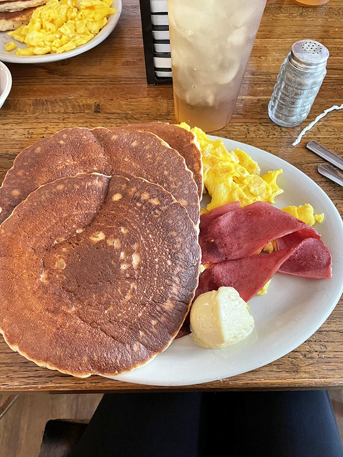 Pancakes so perfectly round and golden they could make the sun jealous. Paired with eggs and ham, it's the breakfast trifecta of champions.