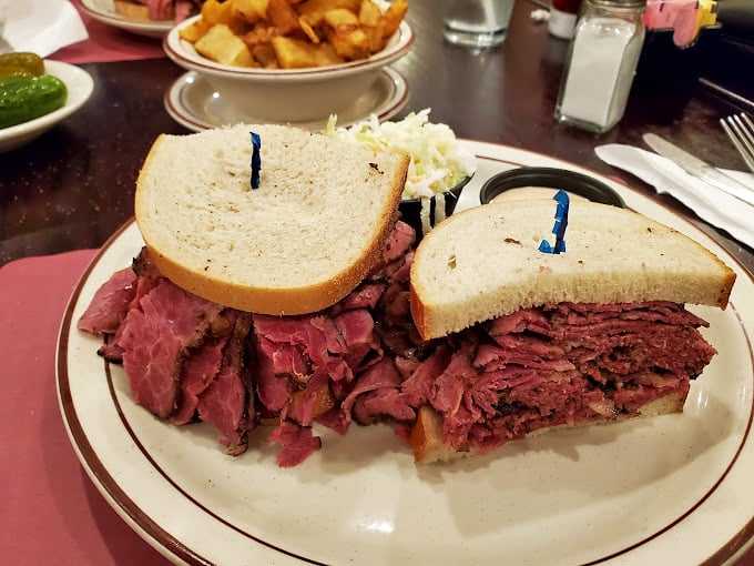 Behold the skyscraper of meat! This sandwich requires both hands, a strategy, and possibly a support group afterward.