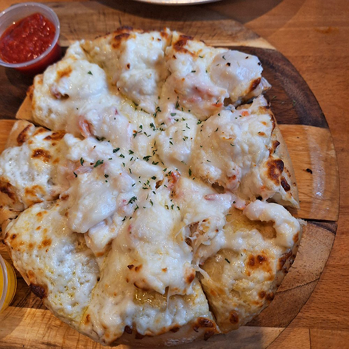 Not your average pizza joint offering. This seafood-topped pie makes you question why you ever settled for pepperoni all these years.