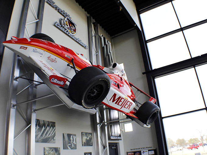 Defying gravity! This Meijer-sponsored Indy car hangs dramatically from the ceiling, demonstrating that in racing, sometimes the fastest way between two points isn't a straight line.