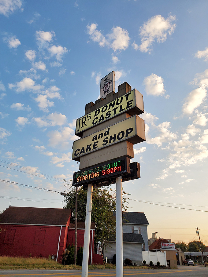 The roadside beacon that guides hungry travelers to donut salvation. That digital clock isn't counting down&mdash;it's counting up to your next sugar rush.