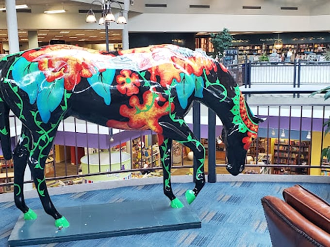Colorful horse sculptures greet you alongside endless bookshelves and cozy seating areas, creating a welcoming space for your next discovery.