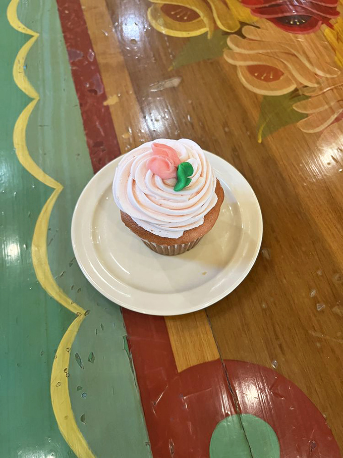 A cupcake wearing its Sunday best! That delicate pink swirl topped with a rosebud is practically begging to star in your Instagram feed.