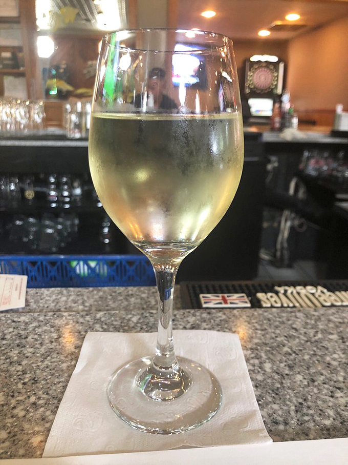 A glass of crisp white wine at the bar&mdash;because nothing says "I'm adulting properly" like pairing good wine with great seafood.