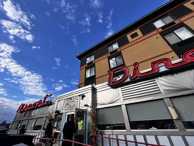 The Airport Diner's sleek silver exterior with bold red signage doesn't just catch your eye&mdash;it practically flags you down for an emergency landing of hunger.