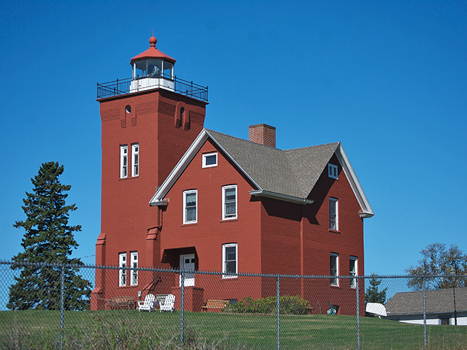 Two Harbors' iconic red lighthouse stands sentinel over Lake Superior, offering postcard views without the premium coastal price tag.