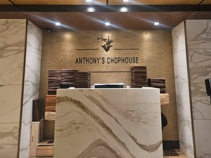 Marble elegance meets seafood excellence at Anthony's reception desk &ndash; where steak house meets ocean treasures.