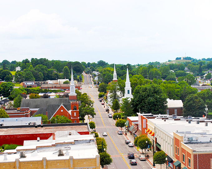 Lush green trees and historic church spires greet you from above during a peaceful, sunny afternoon in scenic downtown Christiansburg.