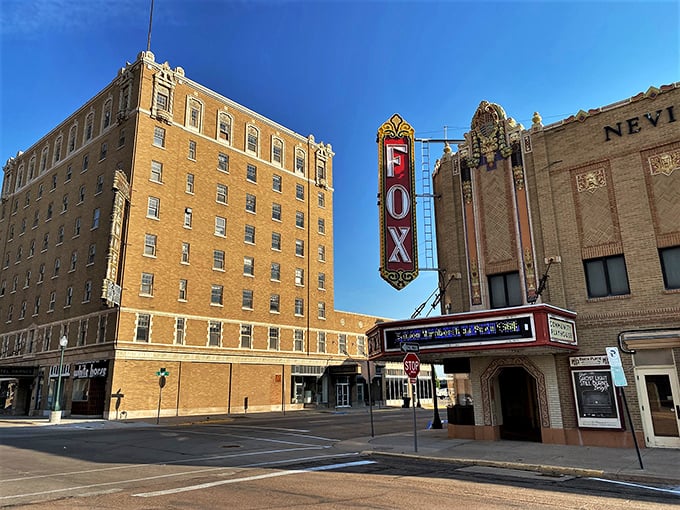 The historic Fox Theater marquee lights up North Platte's night sky—affordable entertainment in a town where Social Security goes the distance.