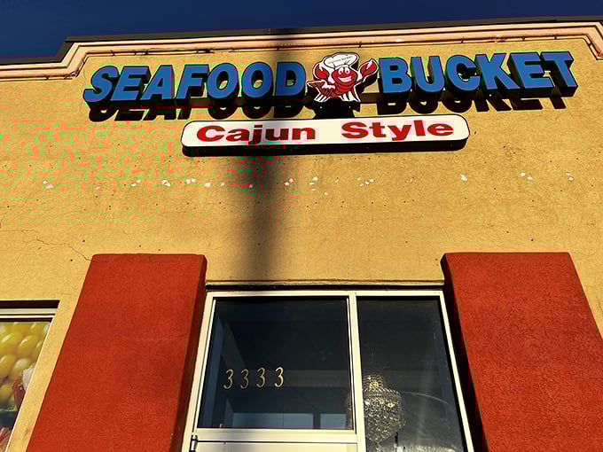 The cheerful crab on Seafood Bucket's sign knows exactly what you're in for&mdash;a gloriously messy seafood feast worth every napkin!