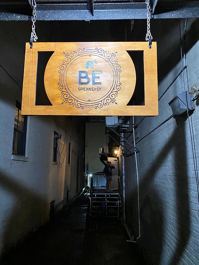 Look for the wooden sign hanging in the alley to find this hidden gem, perfect for your next night out.