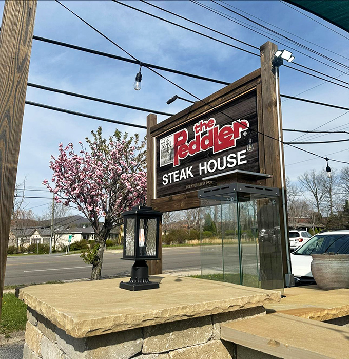 That illuminated sign is basically a lighthouse for hungry travelers searching for the shores of Steak Paradise.